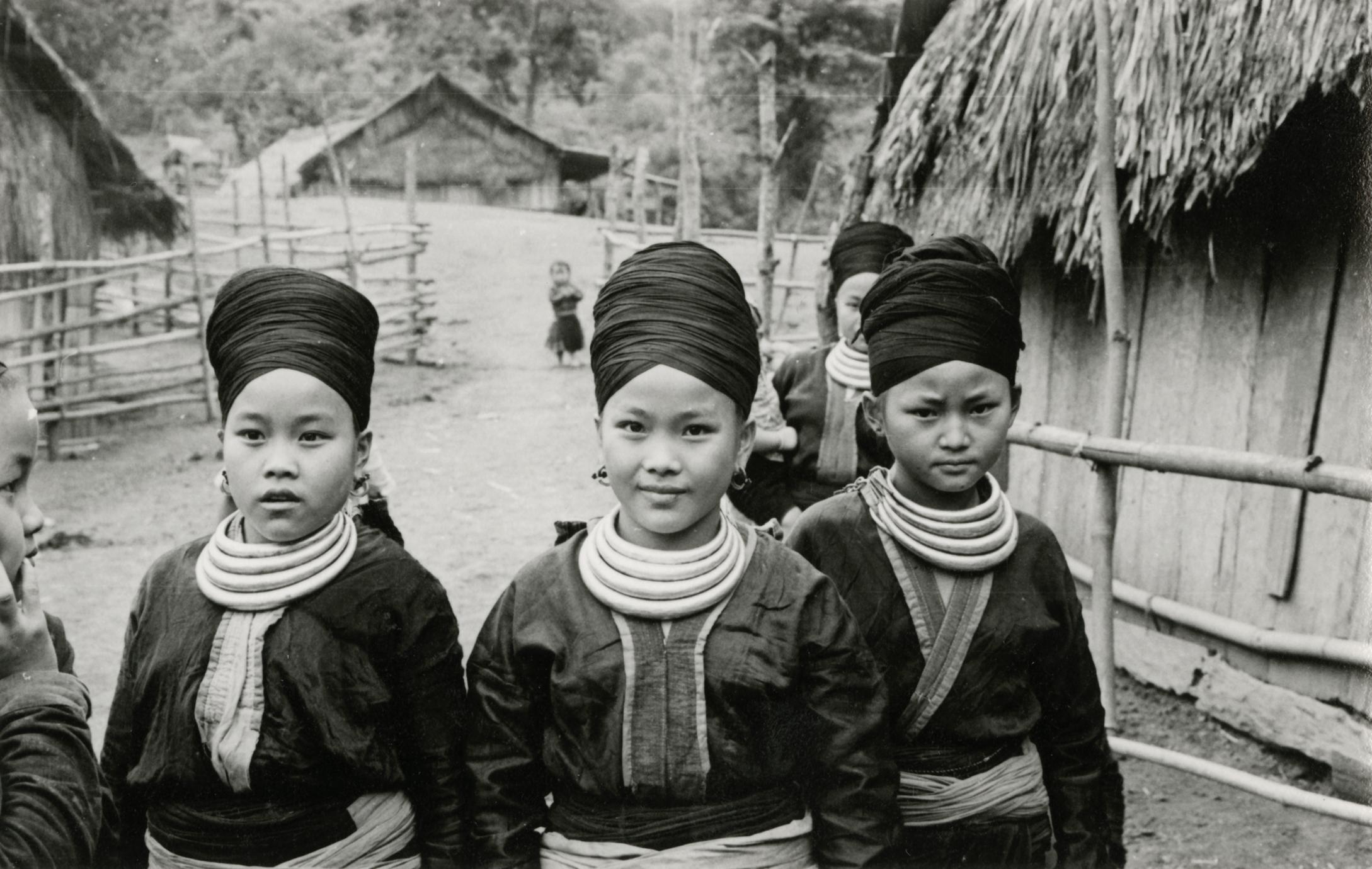 ‎Three Blue Hmong (Hmong Njua) girls stand in their village in the vicinity of Muang Vang Vieng ...